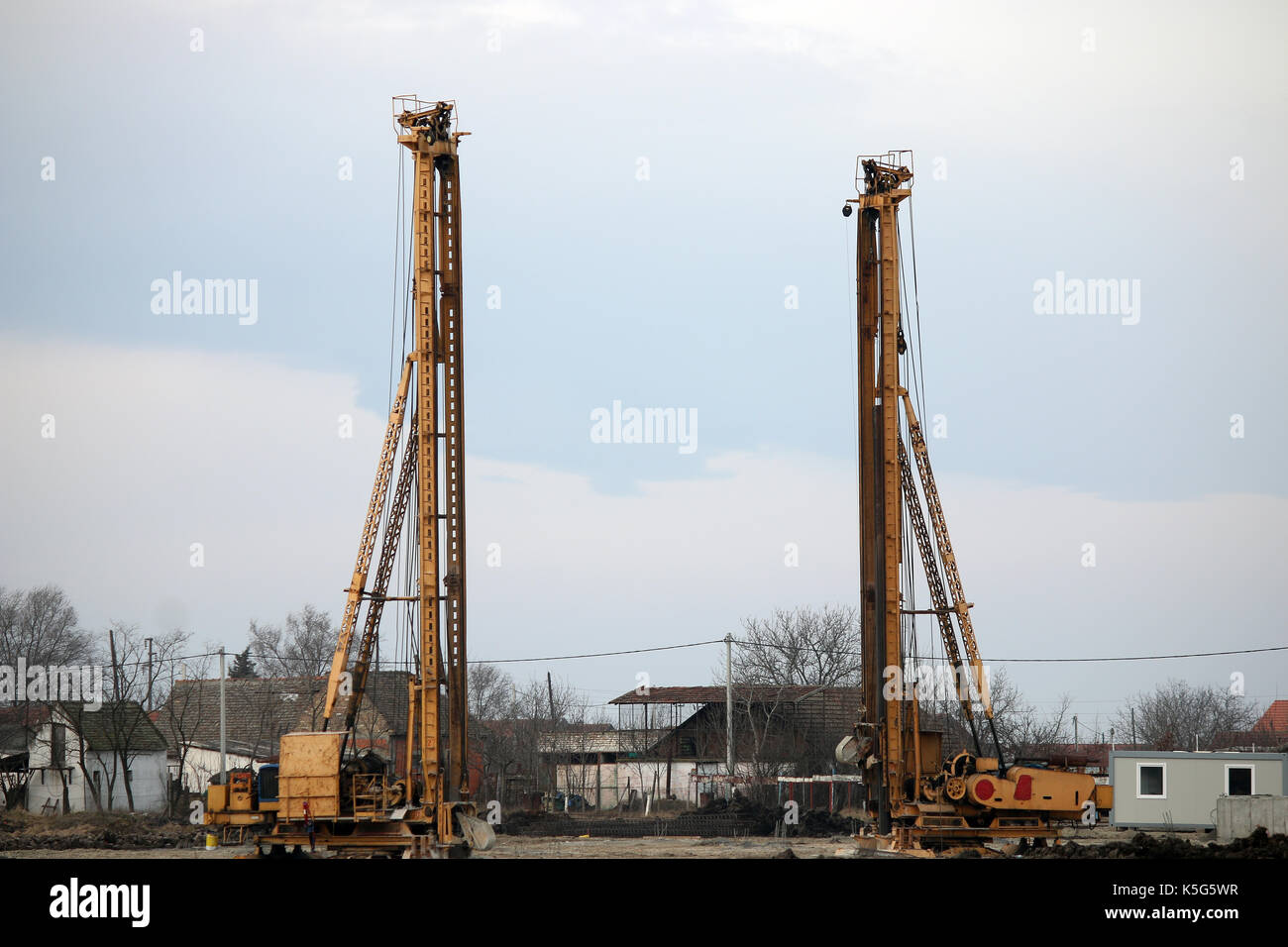 two hydraulic drilling machines on construction site Stock Photo - Alamy