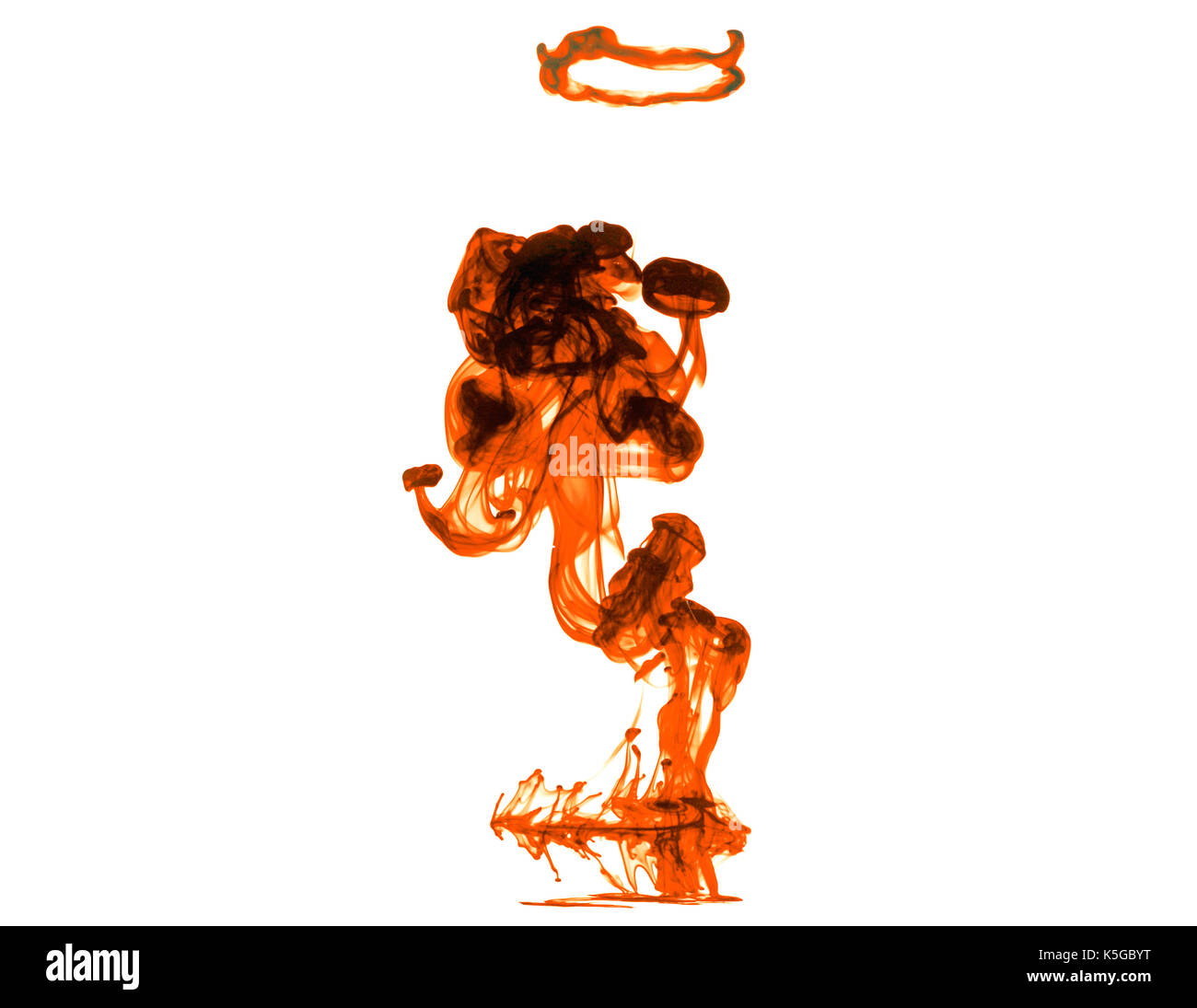 Orange color drop in water photographed in motion. Cloud of red ink in ...