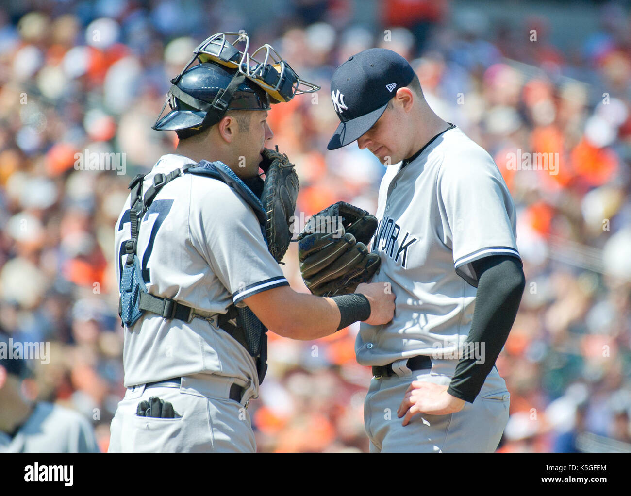 New York Yankees catcher Austin Romine (27), left, offers words of ...
