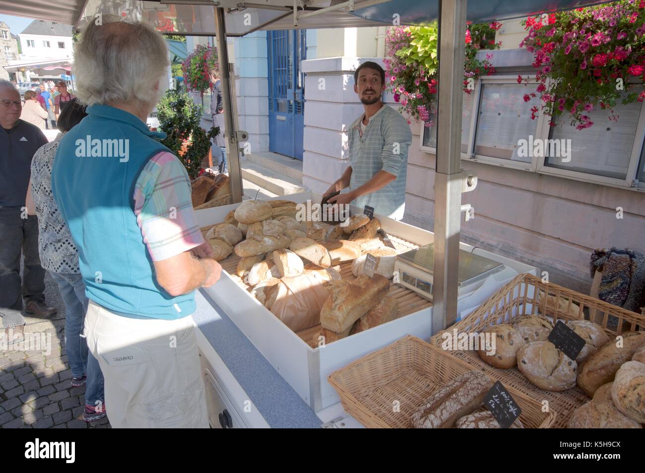 Bread seller at Malestroit market, France Stock Photo - Alamy