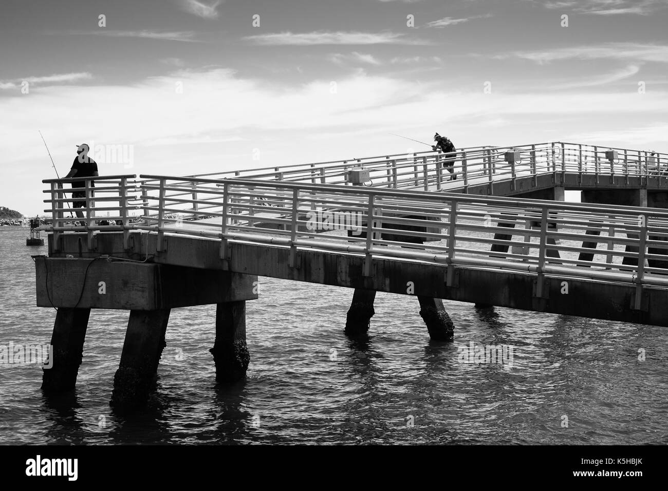 Fishermen on Jetty Park pier in the summer Stock Photo - Alamy