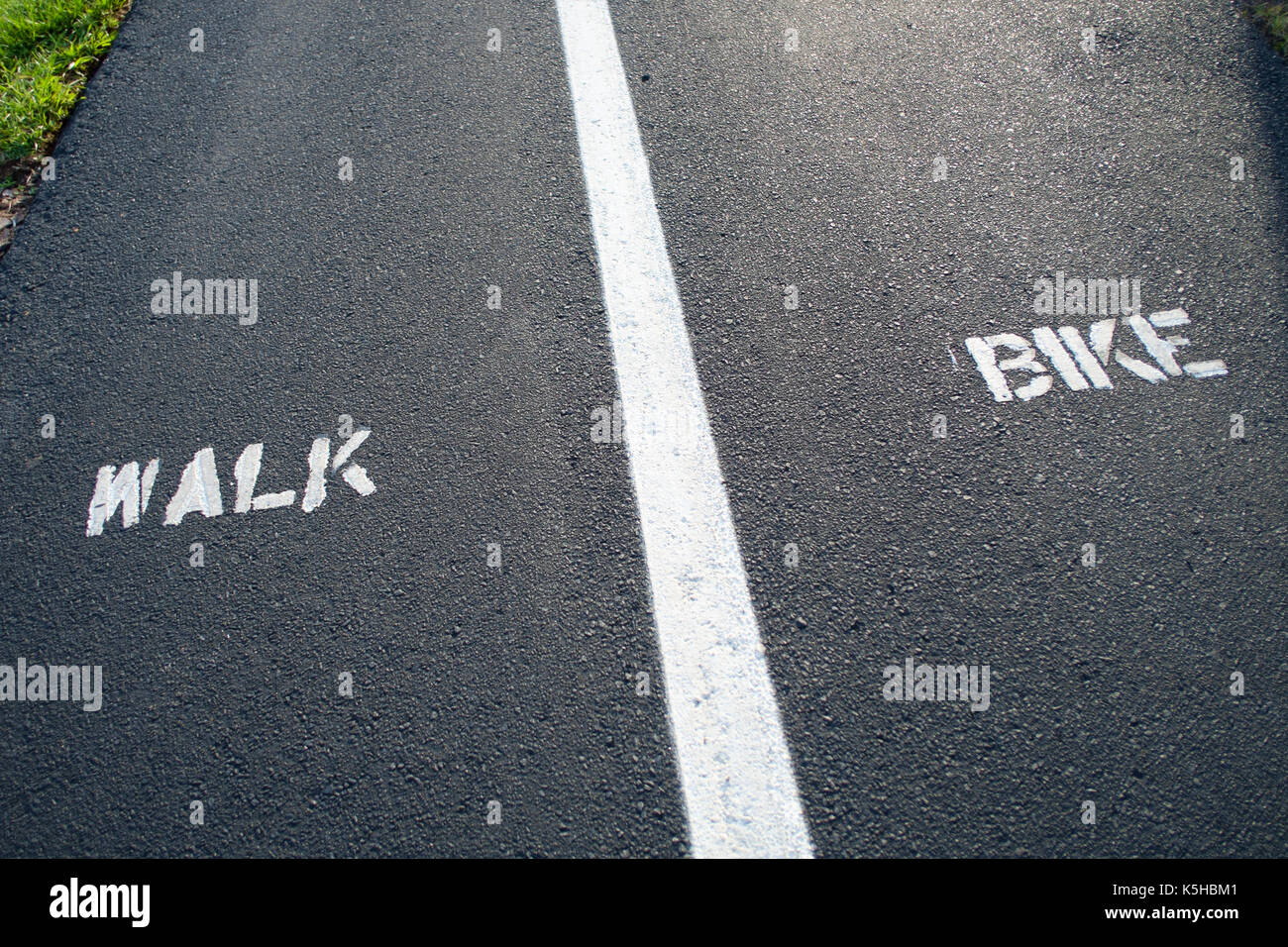 Asphalt path with Walk and Bike lanes painted in white Stock Photo - Alamy