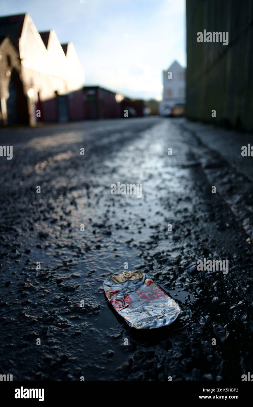 Squashed tin can on road in town side street Stock Photo - Alamy