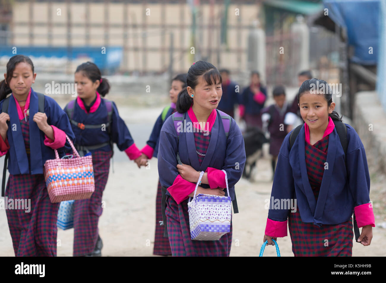 Schoolchildren on their way to the town school wearing traditional ...
