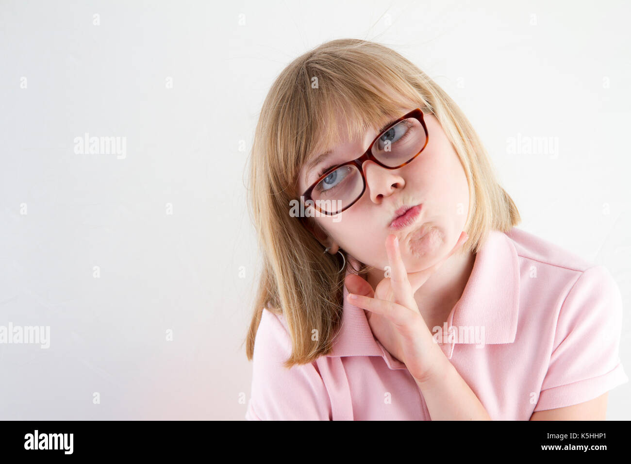 Young girl trying to figure things out Stock Photo - Alamy