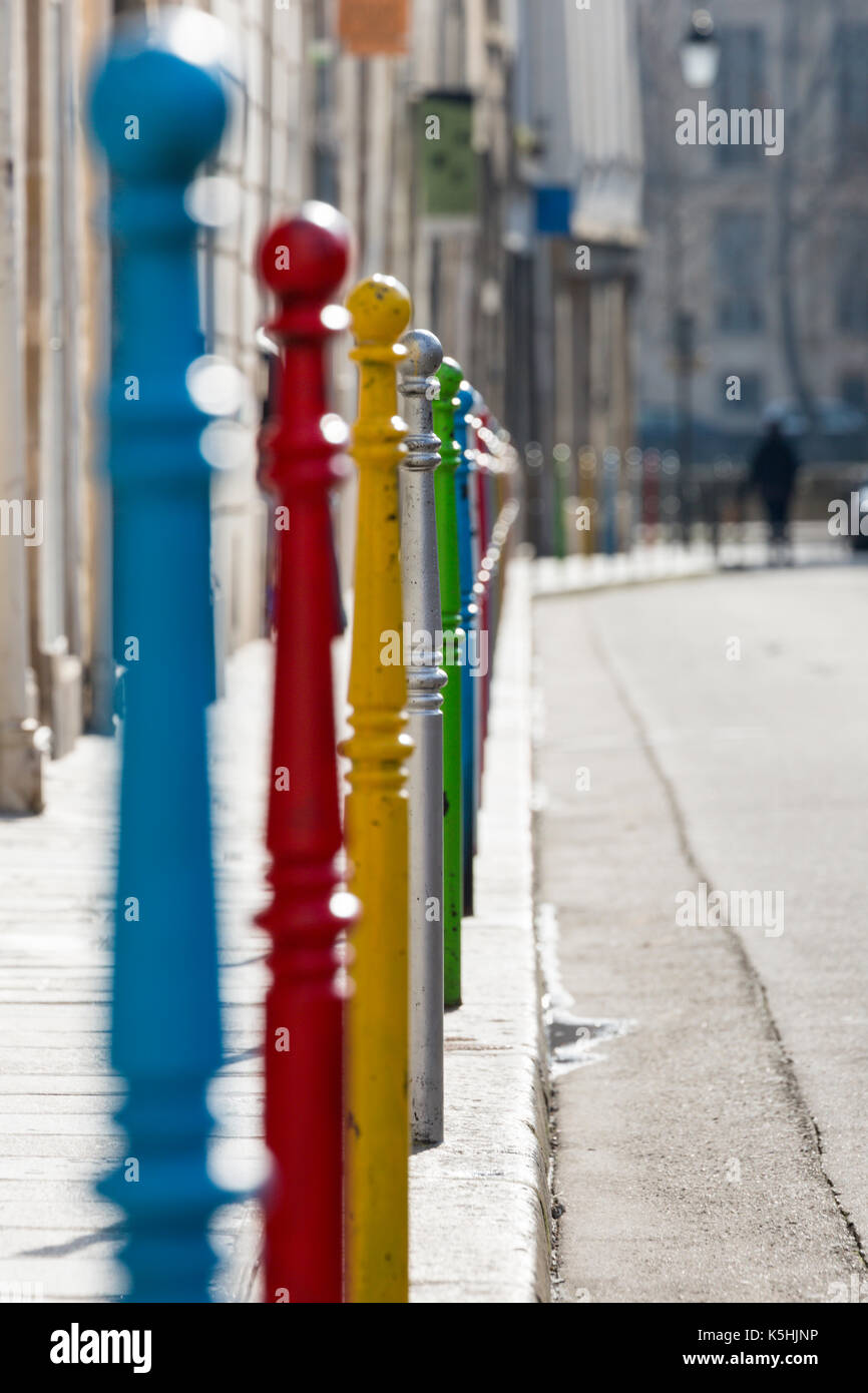Colorful bollards in rue des Jardins Saint-Paul in the Village Saint ...