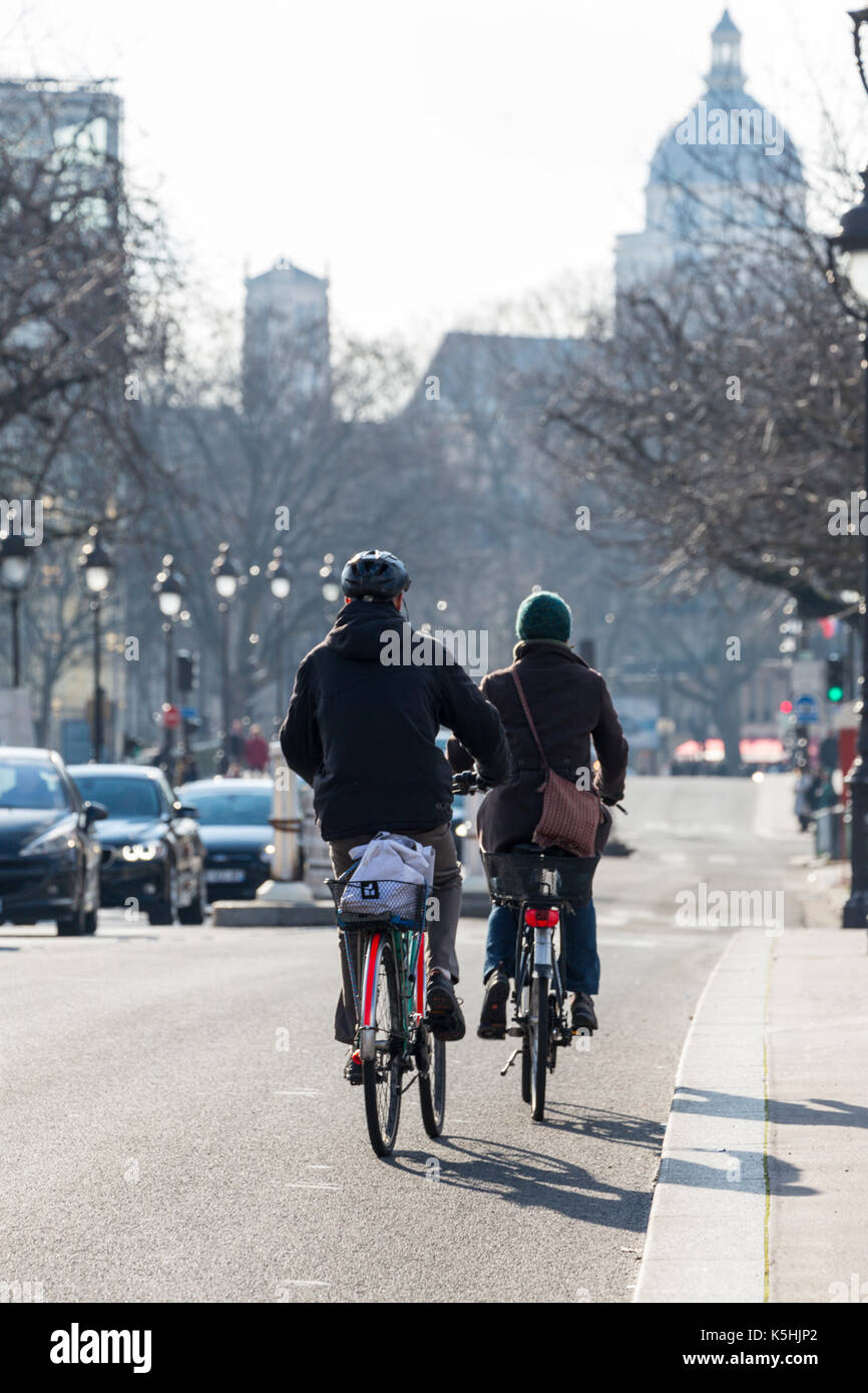 Man and woman on bicycle with riding away from camera Stock Photo - Alamy
