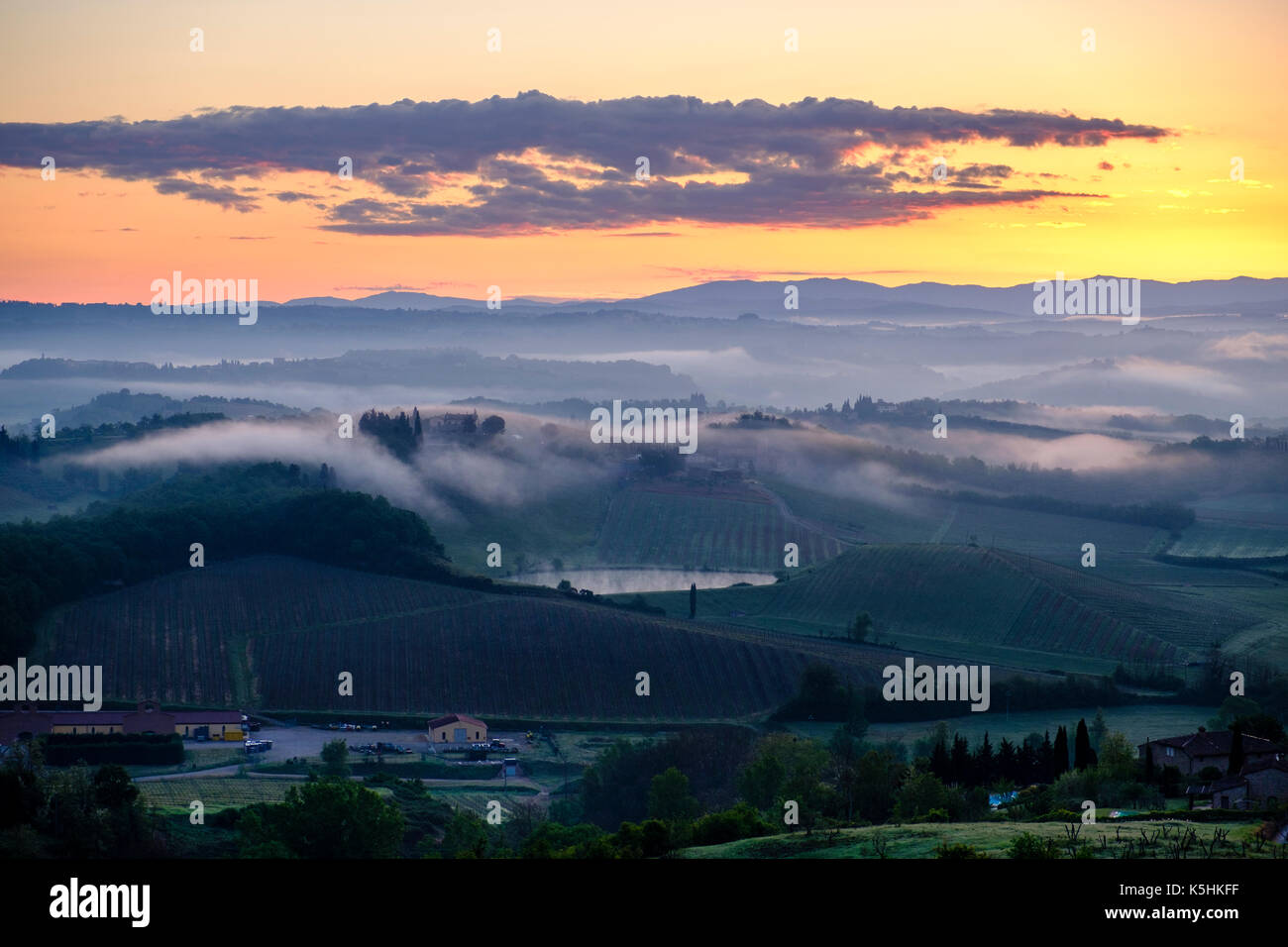 Typical tuscanian landscape with farmhouses on hills, vineyards and ...