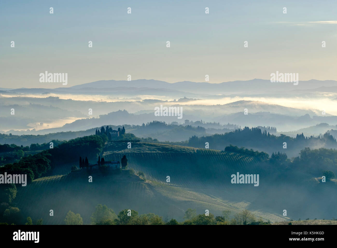 Typical tuscanian landscape with farmhouses on hills, vineyards and ...