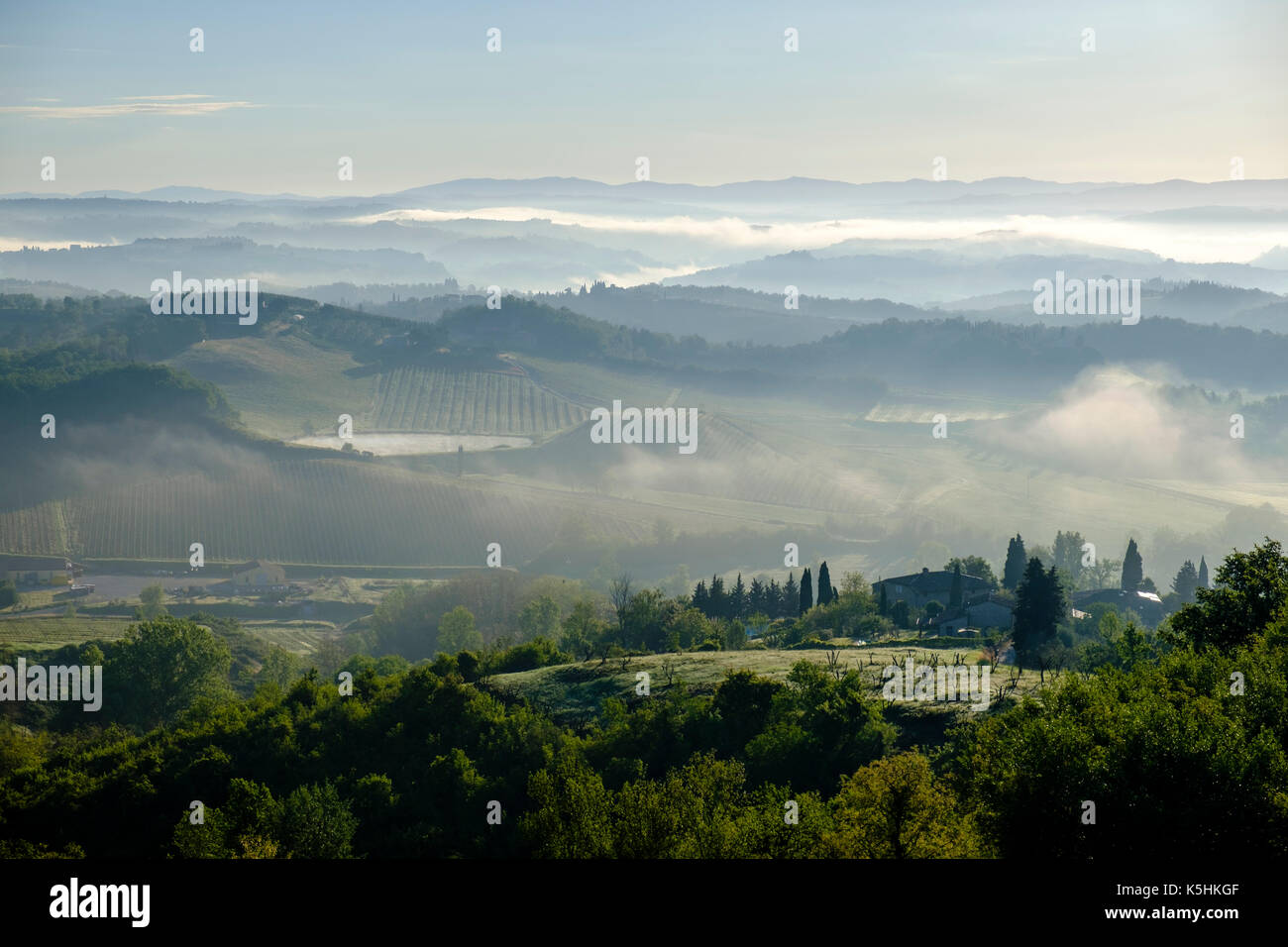 Typical tuscanian landscape with farmhouses on hills, vineyards and ...