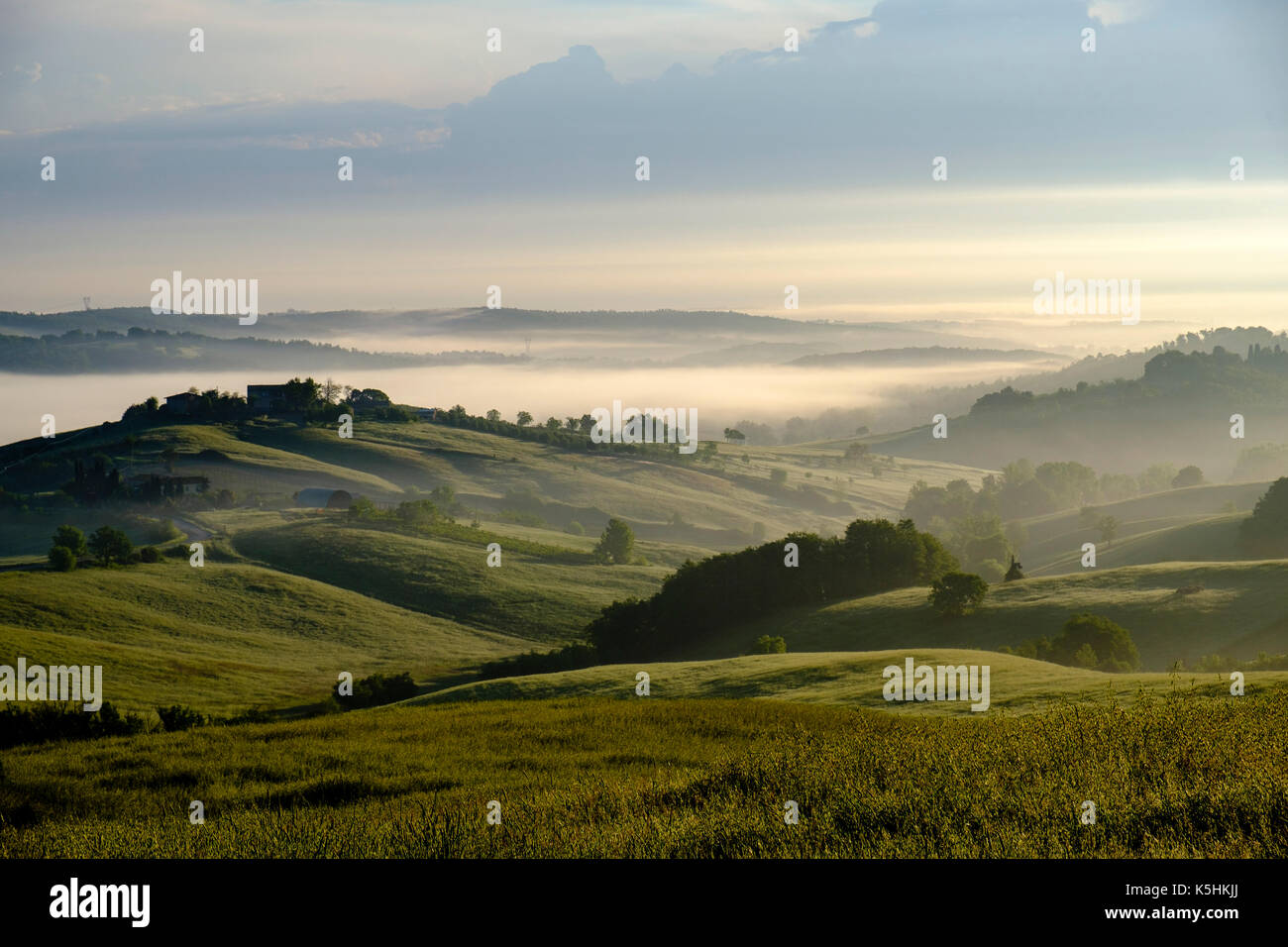 Typical tuscanian landscape with a farmhouse on a hill, fields, trees ...