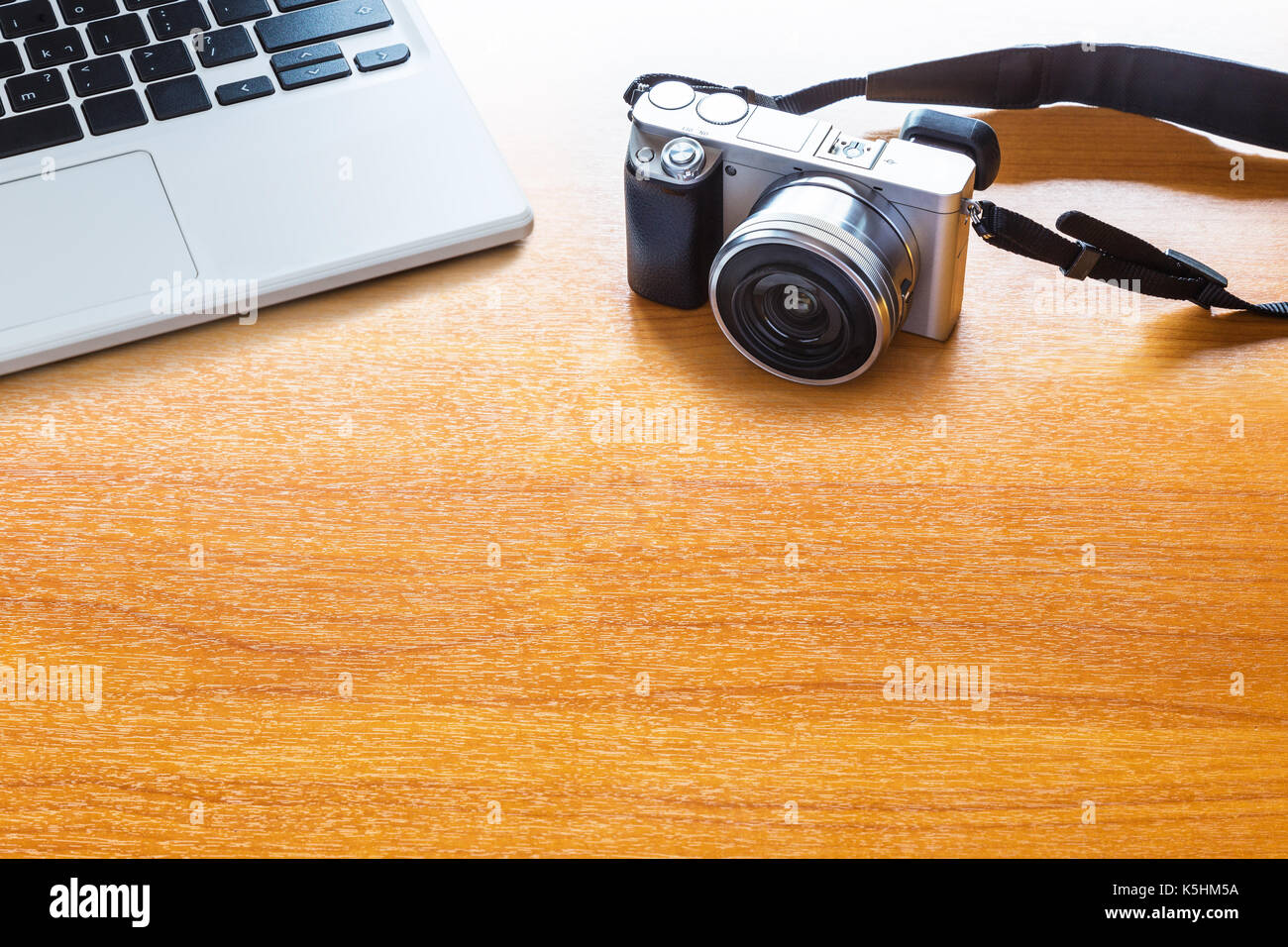 digital photography concept with mirrorless camera and laptop computer ...