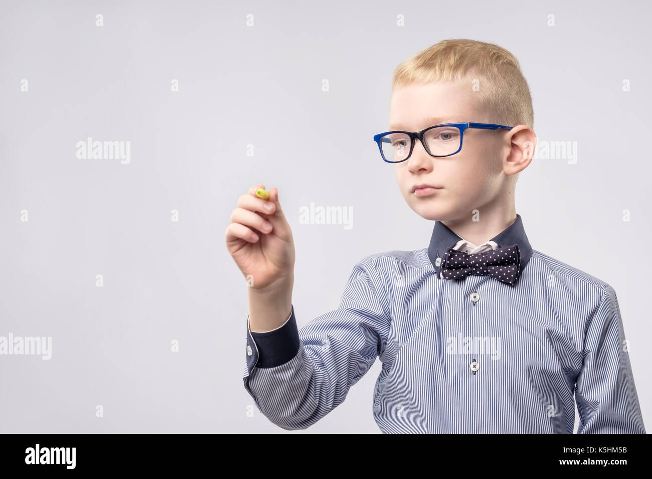 Teenage Boy writing with yellow pencil Stock Photo - Alamy