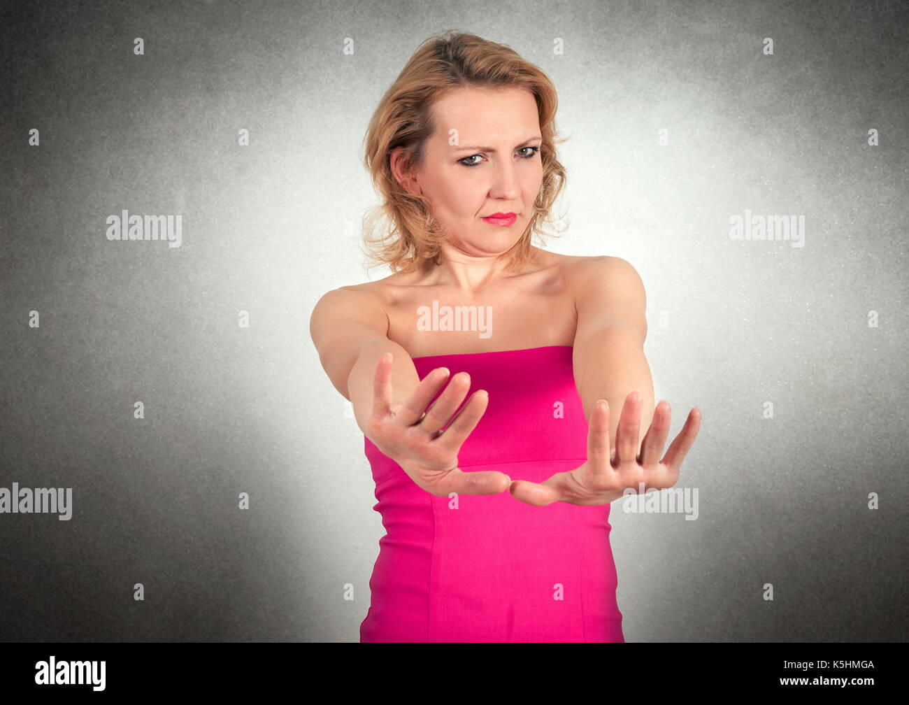 Beautiful blond woman with stop sign Stock Photo - Alamy