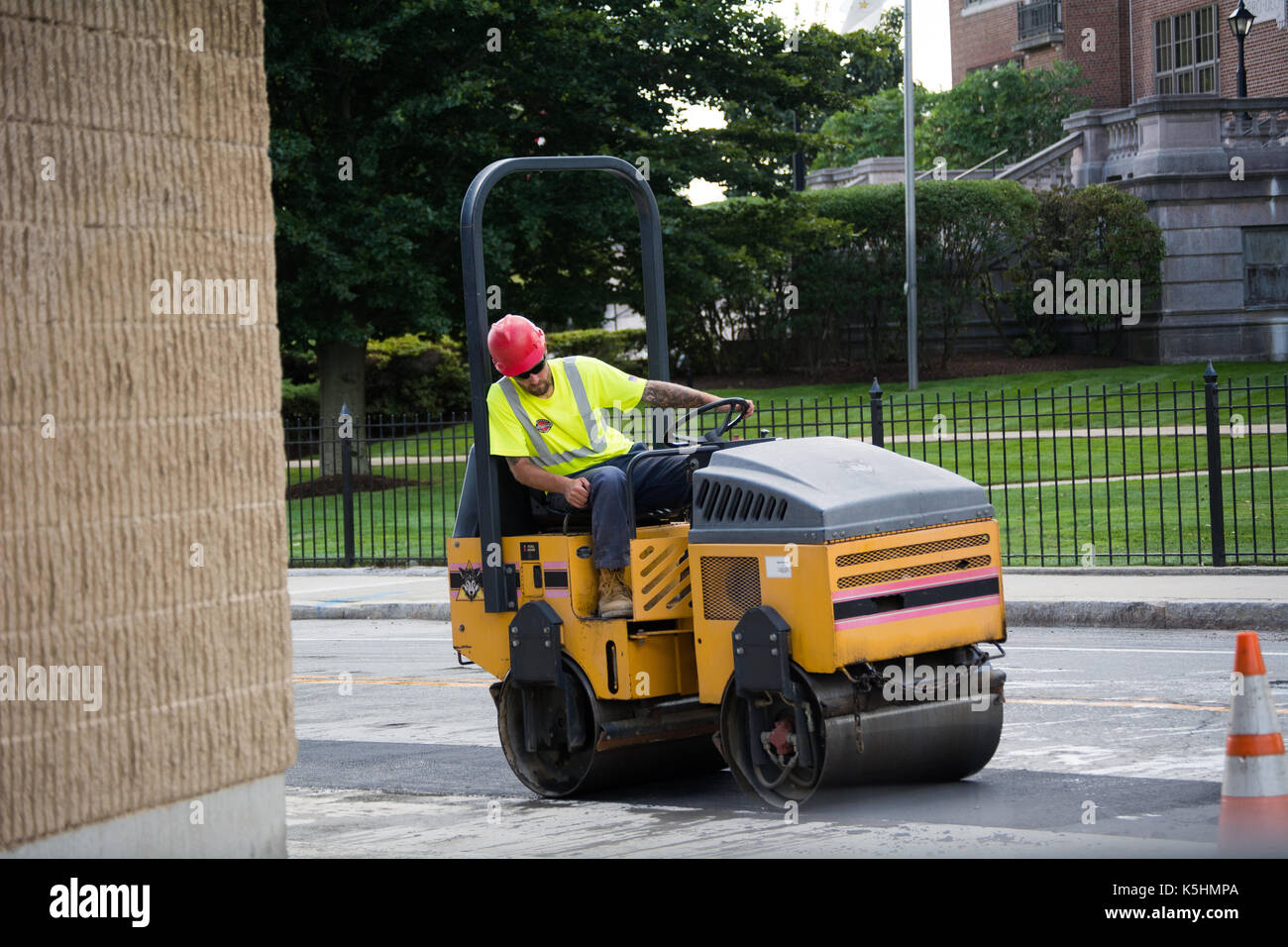 A construction roller patching a city street Stock Photo - Alamy