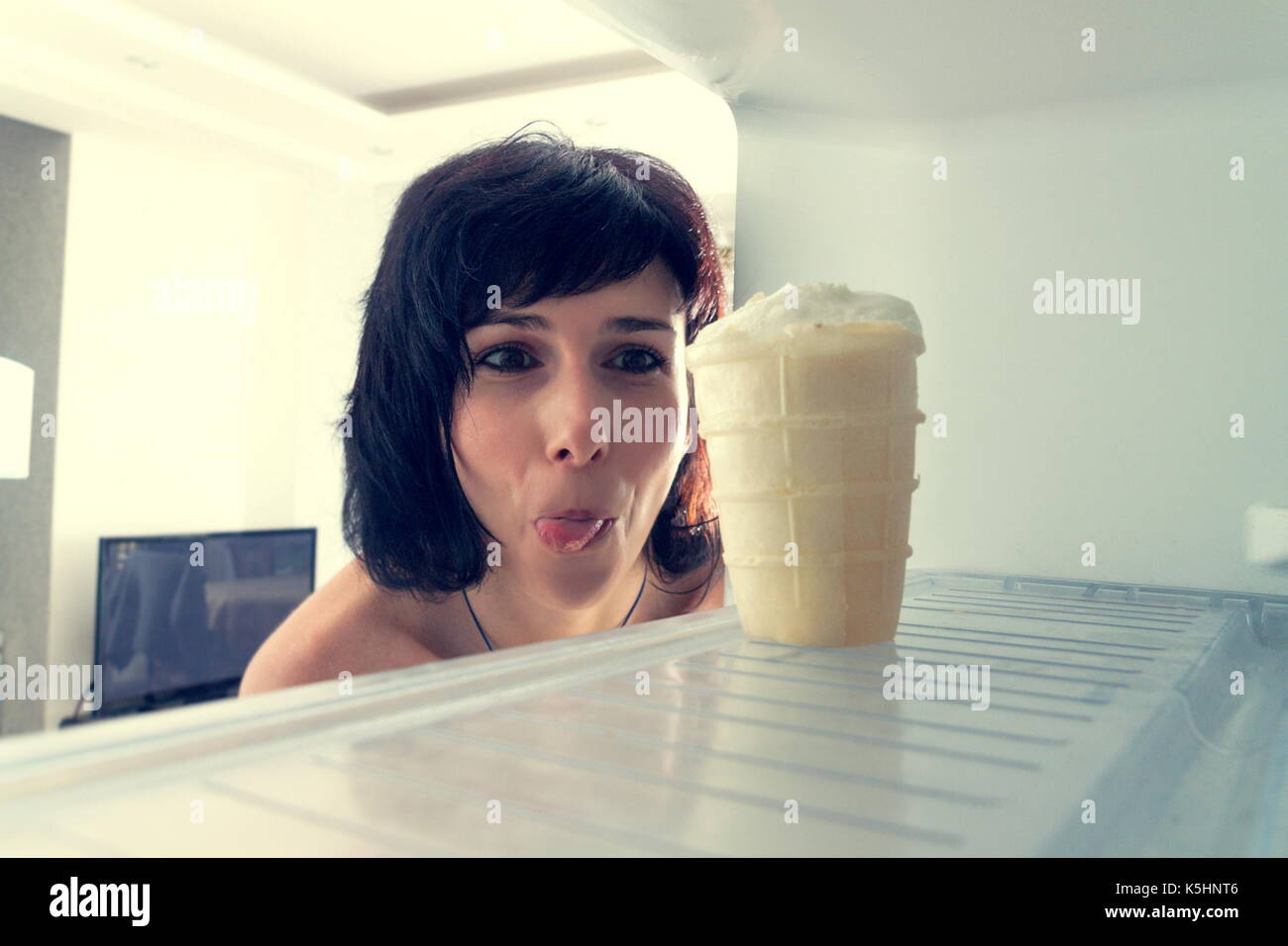 Woman sees ice cream in the fridge Stock Photo - Alamy