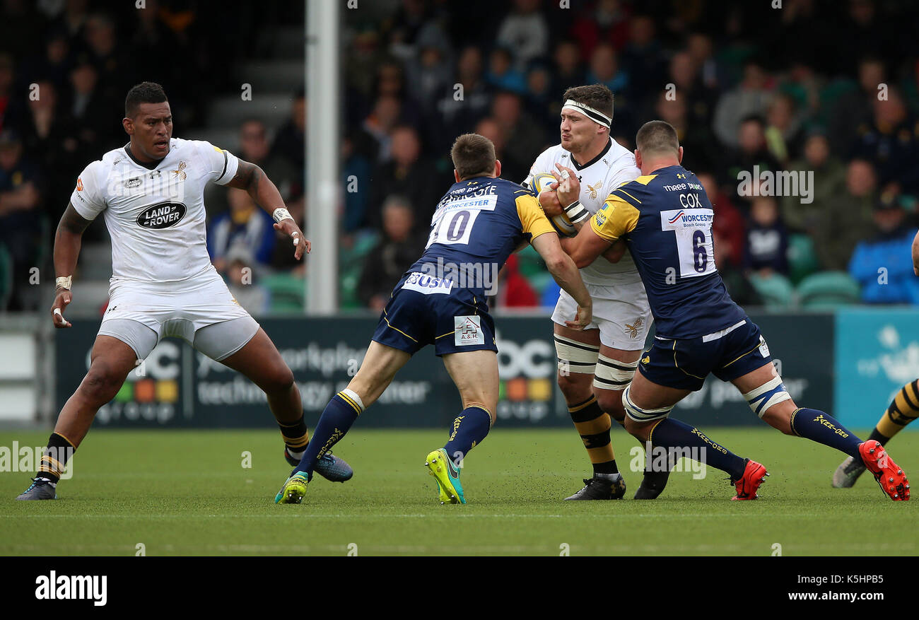 Worcester Warriors Tom Heathcote (left) and Matt Cox tackle Wasps Guy ...