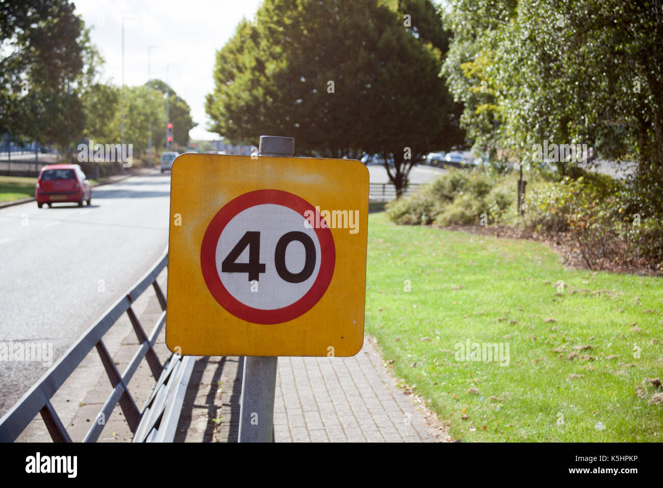Warning sign or road sign for the maximum speed limit next to the busy ...