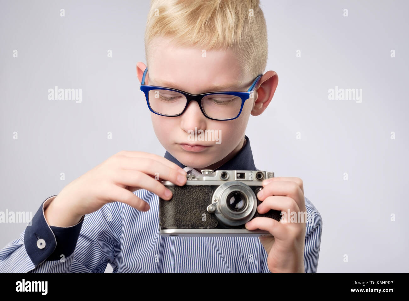 Cheerful smiling child boy holding a instant camera Stock Photo - Alamy
