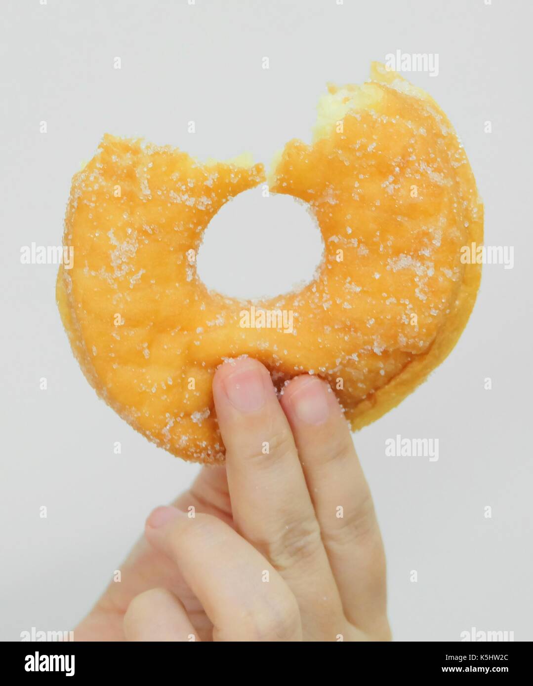 Hand holding donut hi-res stock photography and images - Alamy