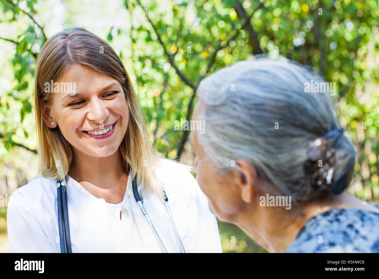 Senior lady with multiple medical conditions talking to female ...