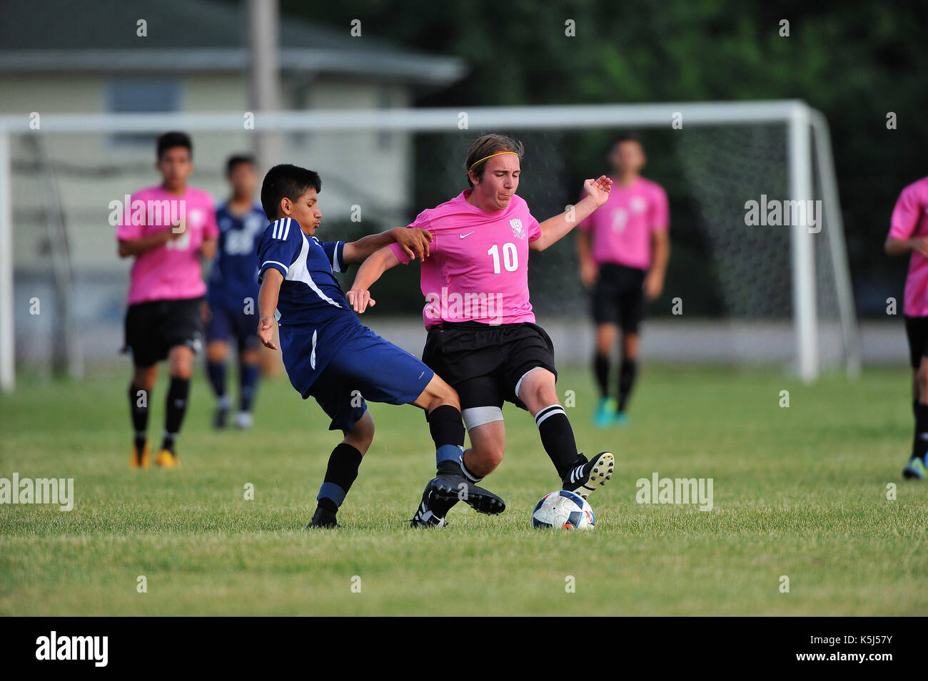 Defender makes contact with a forward driving down the sideline Stock ...