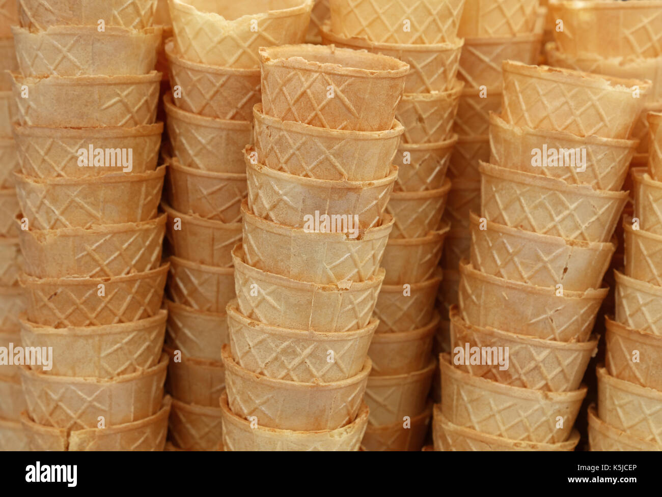 Background of empty fresh wafer ice cream cone cornet cups in row ...