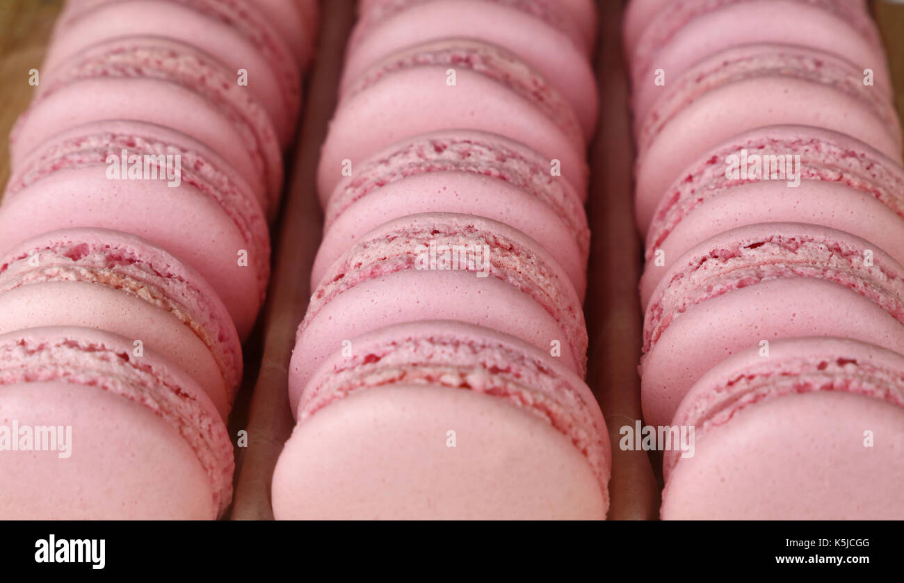 Fresh baked pink macaroon pastry cookies (macarons, macaroni) in retail ...