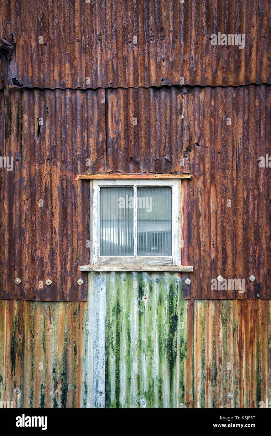 rusty corrugated iron building, warehouse with window Stock Photo - Alamy