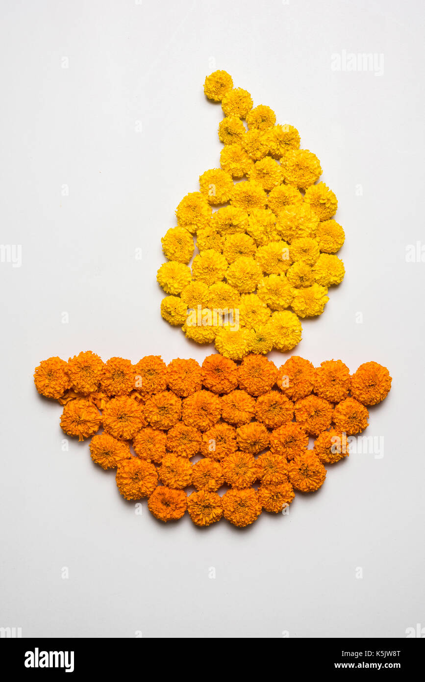 stock photo of marigold flower rangoli in shape of Diya. Diya made ...