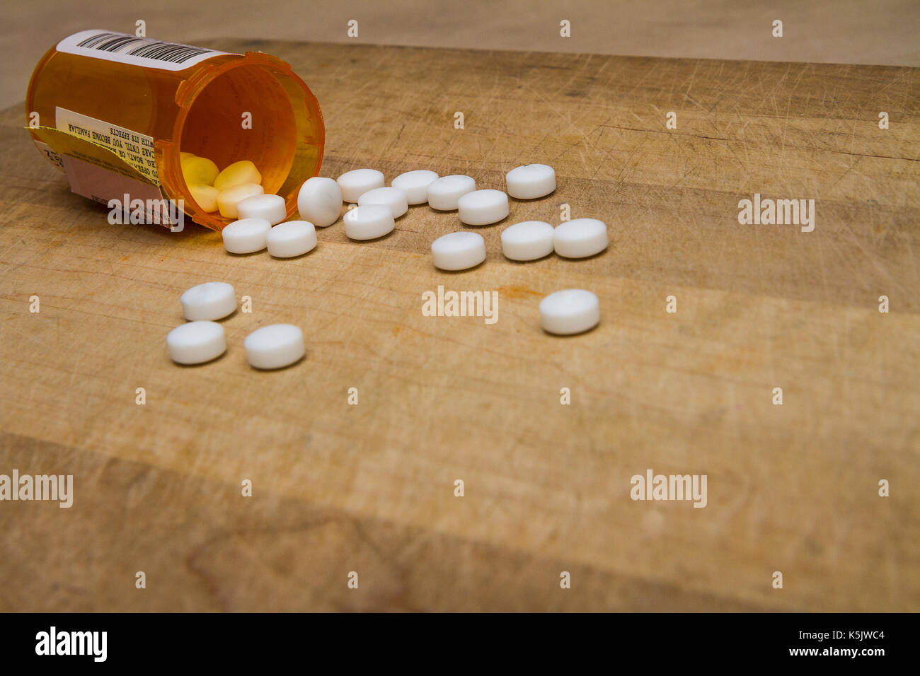bottle with pills falling out Stock Photo - Alamy