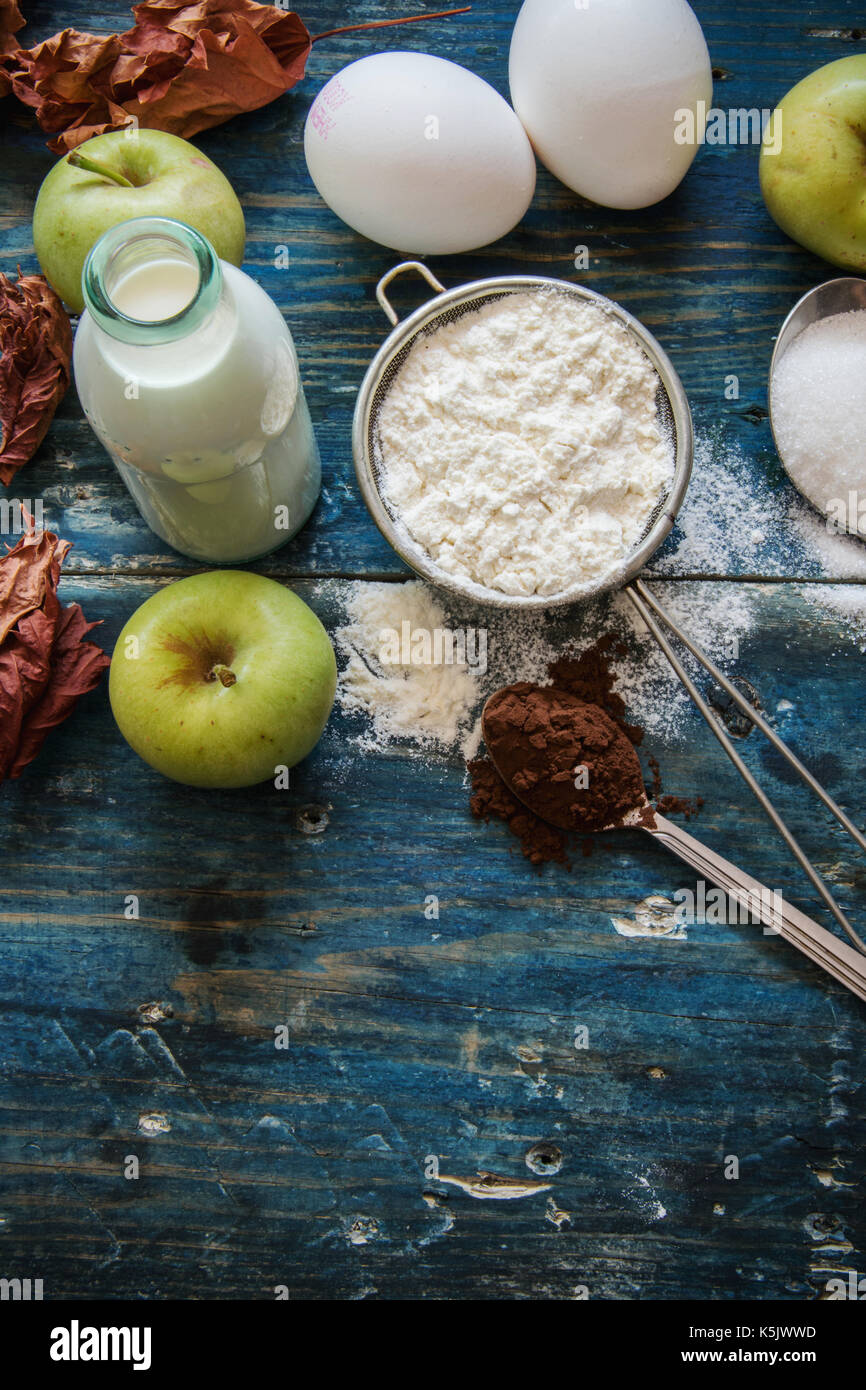 Genuine ingredients for the cake - apple, milk, flour, eggs and cacao ...