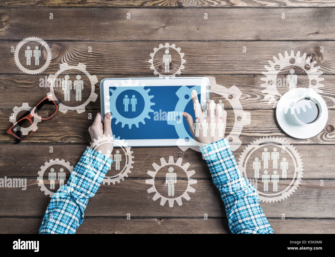 Concept of teamworking and connection with gears mechanism and tablet ...
