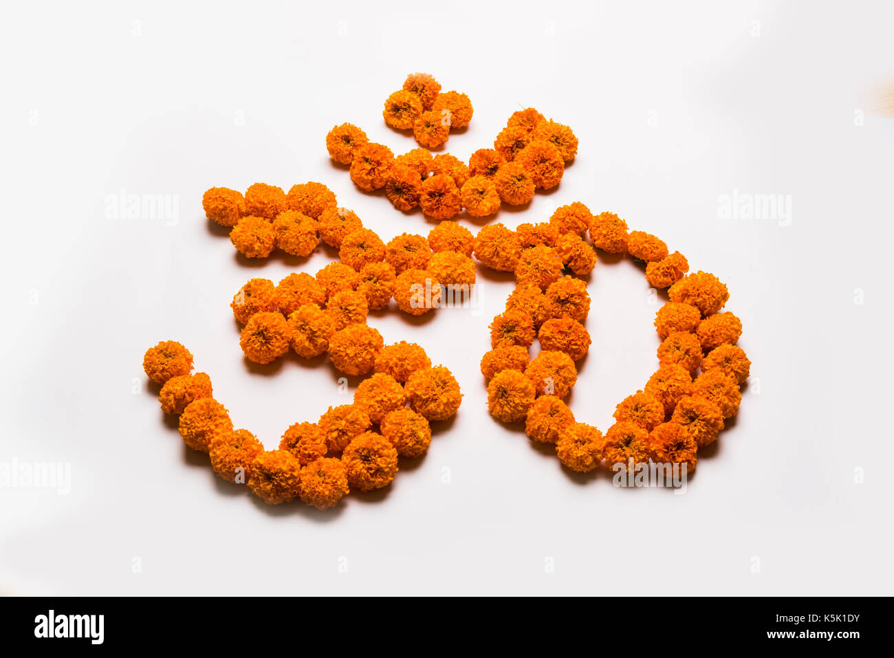 Stock photo of word Aum or om made using marigold flower arrangement ...