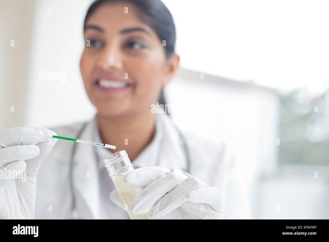 Female doctor testing urine Stock Photo - Alamy