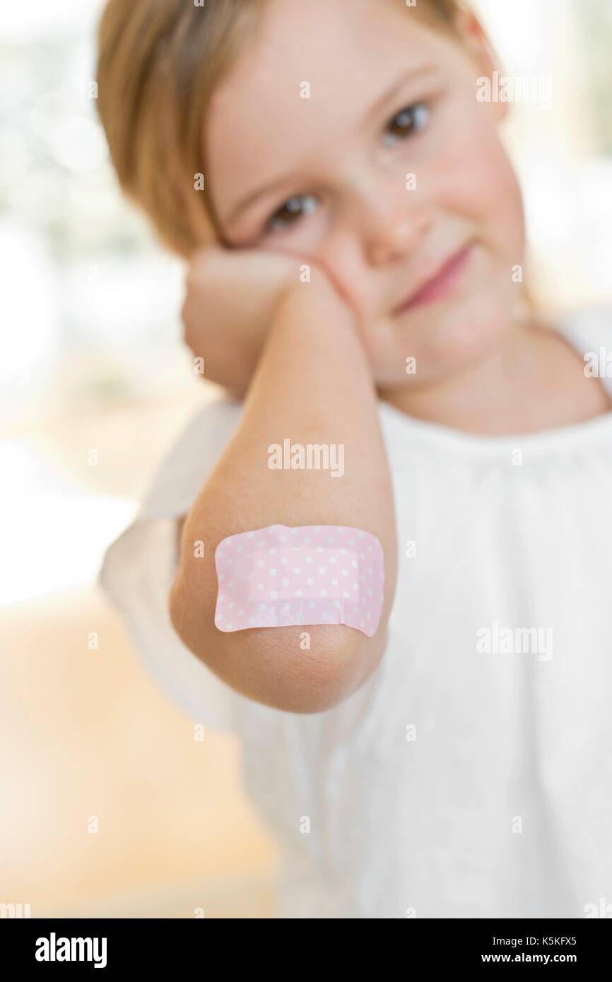 Young girl with plaster on elbow Stock Photo - Alamy