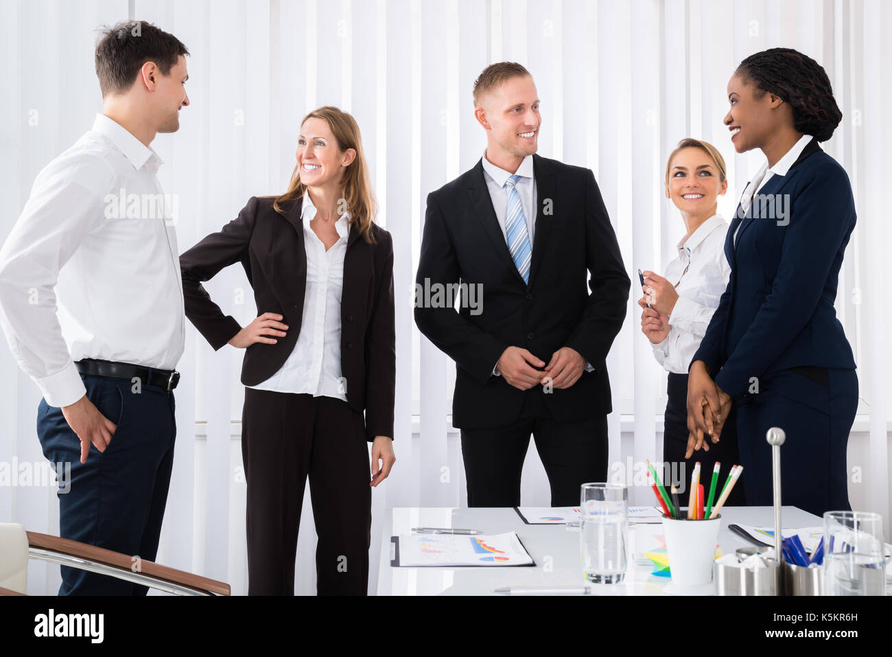 Happy Successful Businesspeople Having Conversation In Office Stock ...