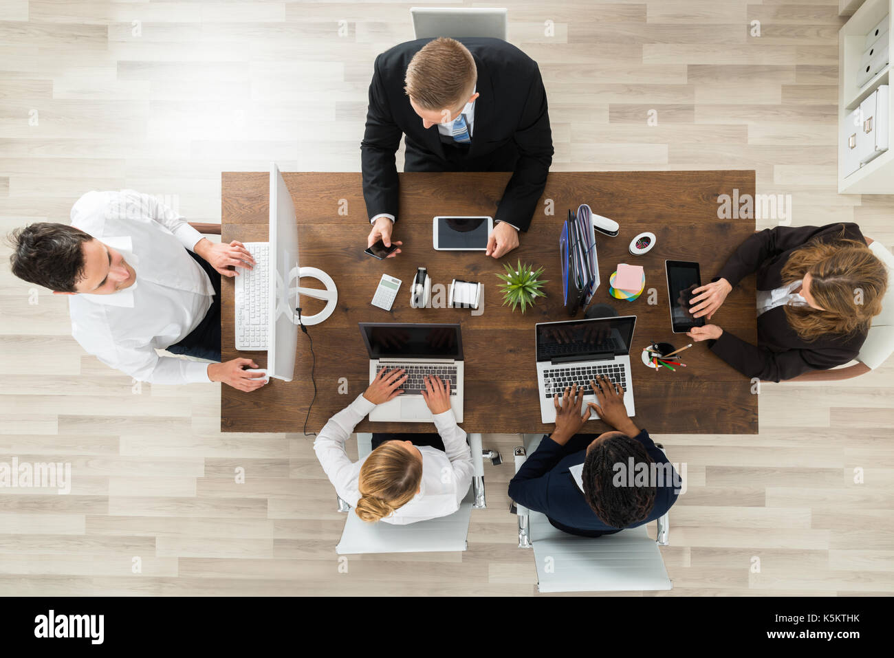 Professional Businesspeople Using Computers And Laptops In Office Stock ...