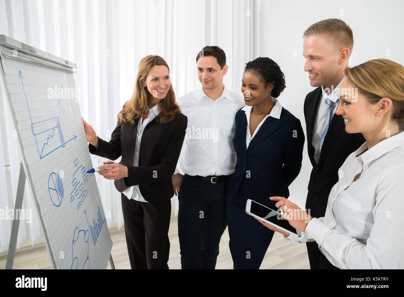 Happy Female Manager Explaining Business Strategy To The Staffs In ...