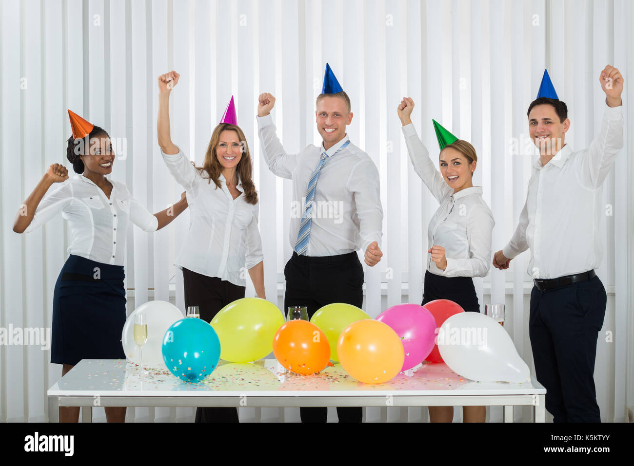 Group Of Happy Businesspeople Celebrating Success During Party In ...