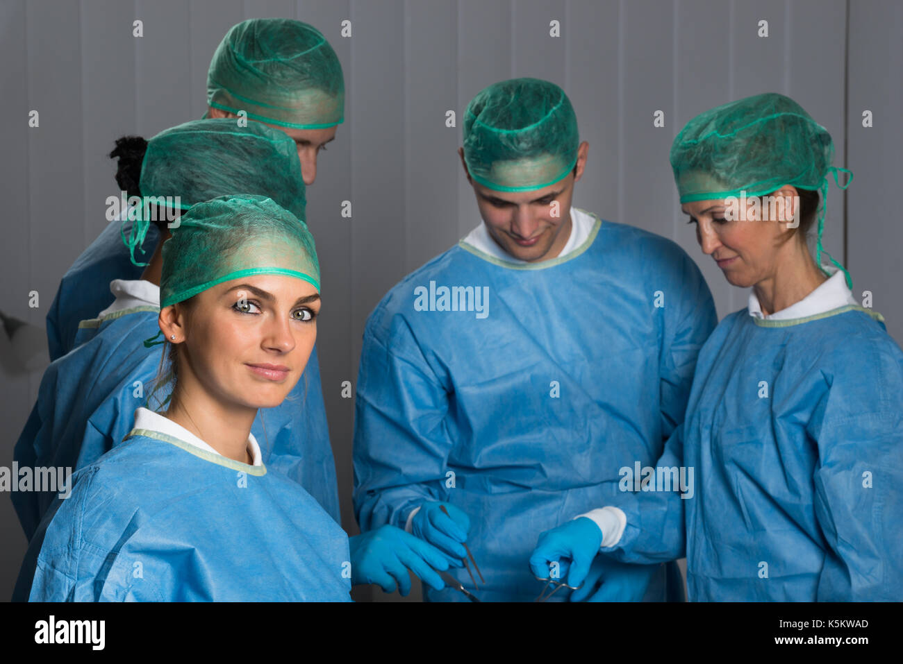 Group Of Doctors Wearing Blue Scrubs In Operating Room Stock Photo - Alamy