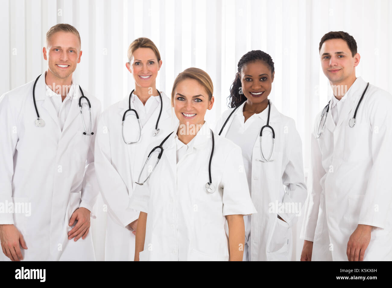 Group Of Happy Doctors With Stethoscope Standing In Hospital Stock ...