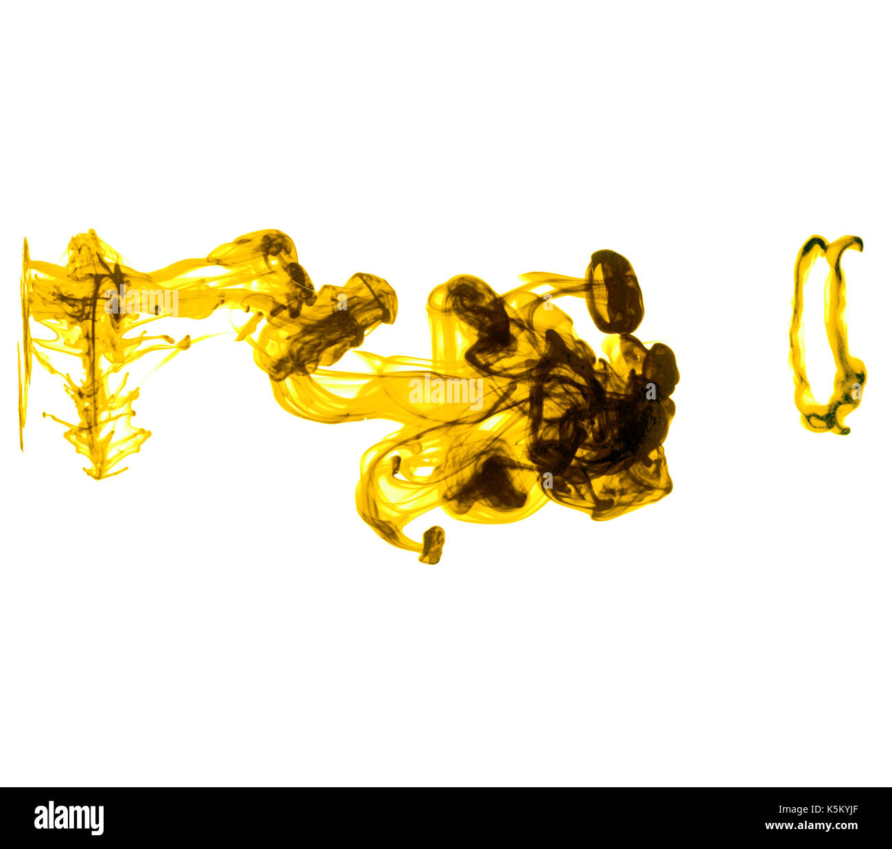 Yellow color drop in water photographed in motion. Cloud of red ink in ...