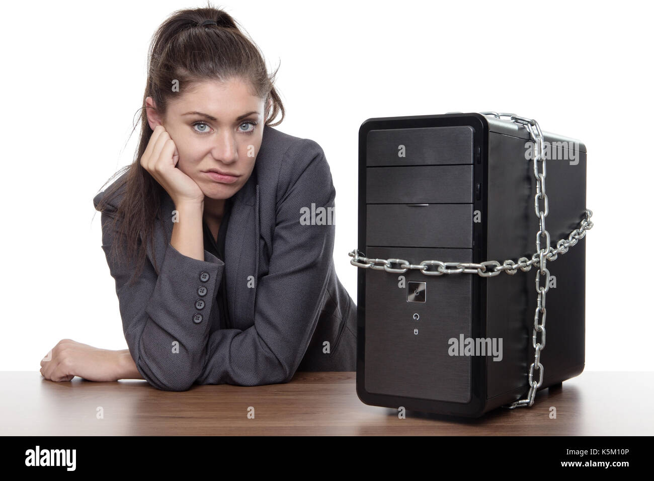 Computer locked up and business woman not looking very happy unsure ...