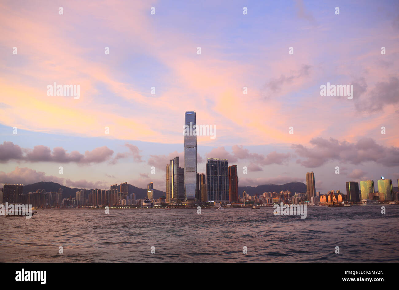 Hong Kong victoria harbour skyline in sunset glow Stock Photo - Alamy