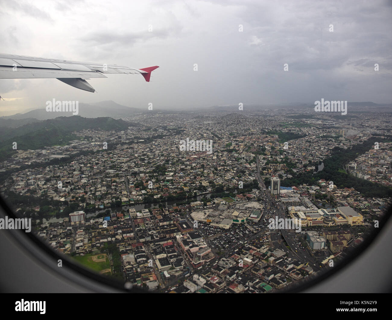 GUAYAQUIL, ECUADOR - 2017: Aerial view of the city through an airplane ...