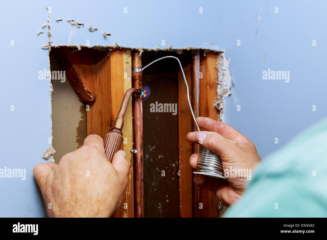 metal pipes and fittings of domestic water supply system seen through a ...