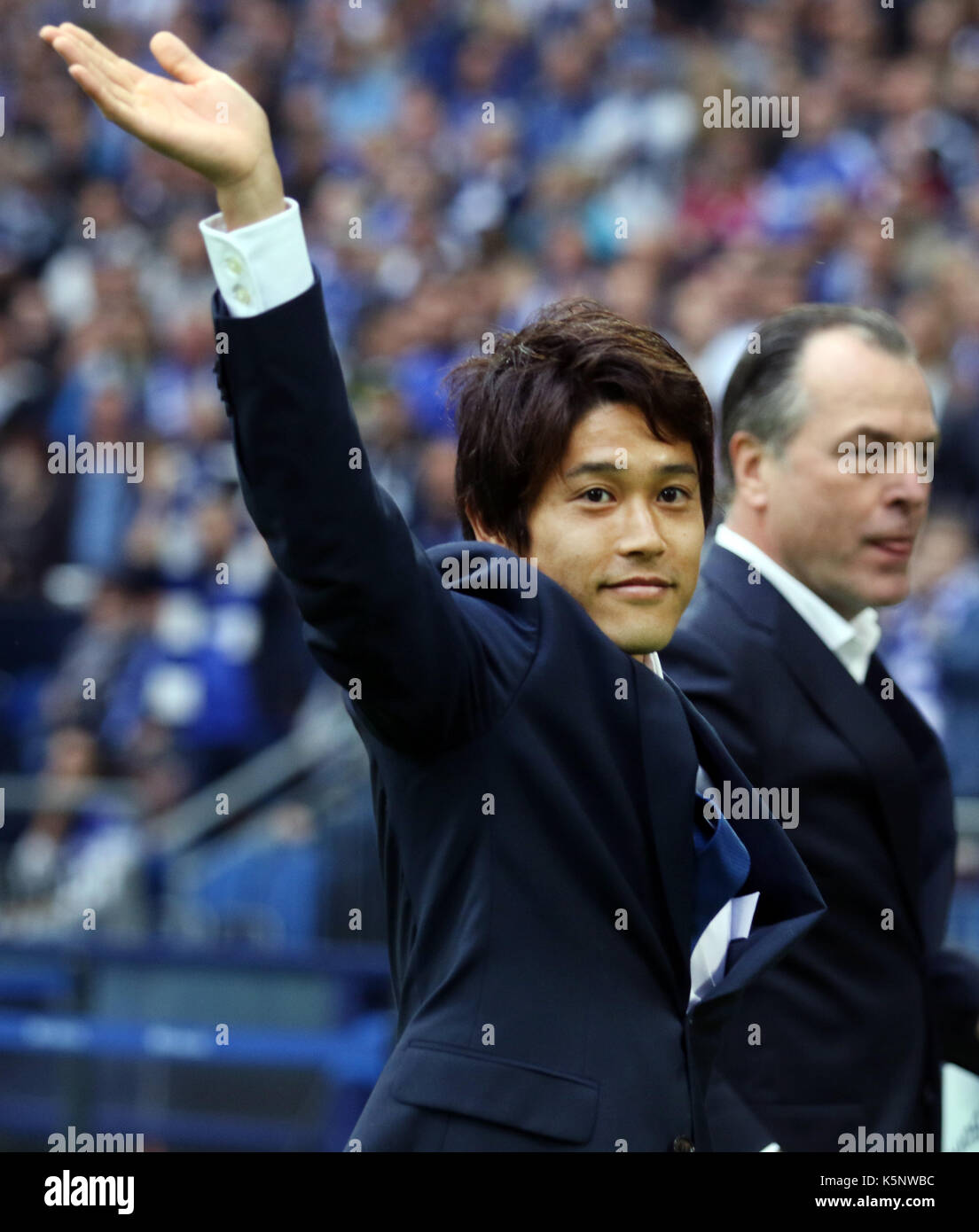 Former Schalke-player Atsuto Uchida (L) waves goodbye to the fans ...