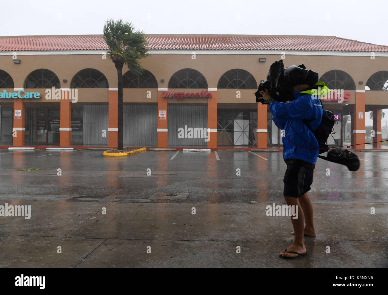 Miami, USA. 10th Sep, 2017. A cameraman takes video among rain and ...