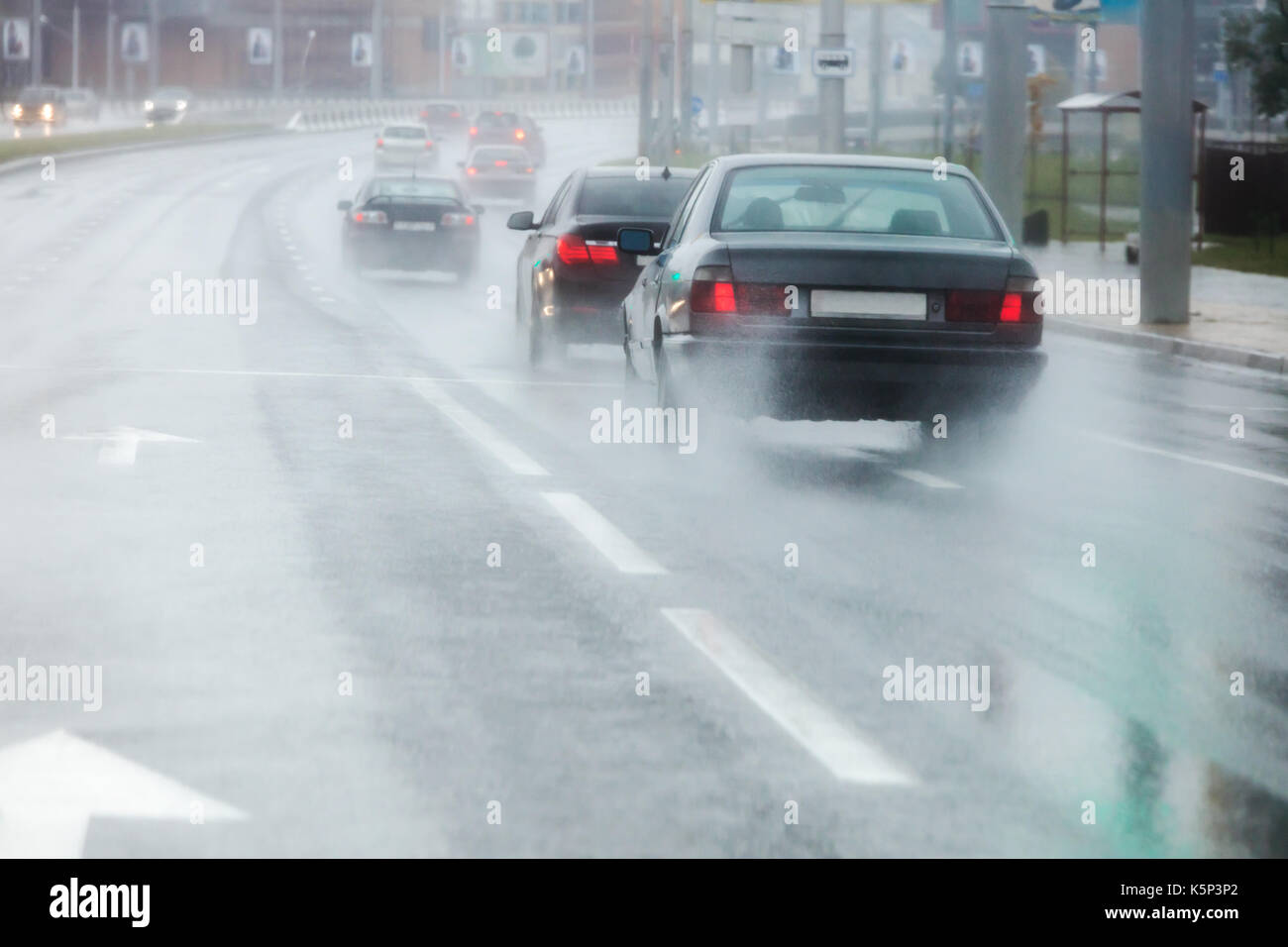 traffic during bad weather. moving cars spraying rain puddles Stock ...